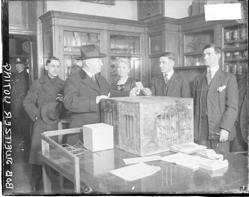 ECC | [Robert M. Sweitzer, Cook County clerk, voting in a room wit