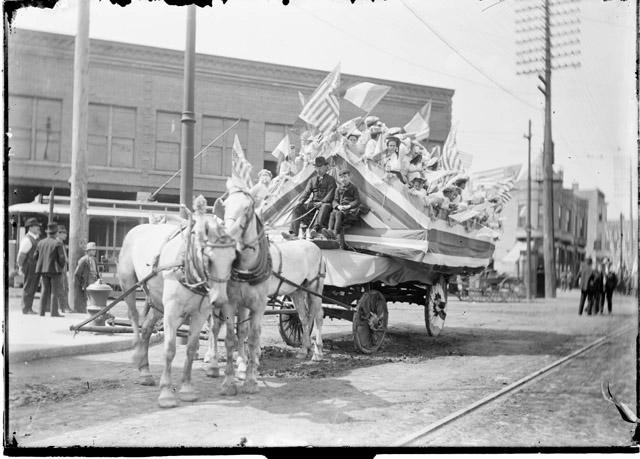 ECC | [Wagon carrying girls waving flags during a church picnic pa