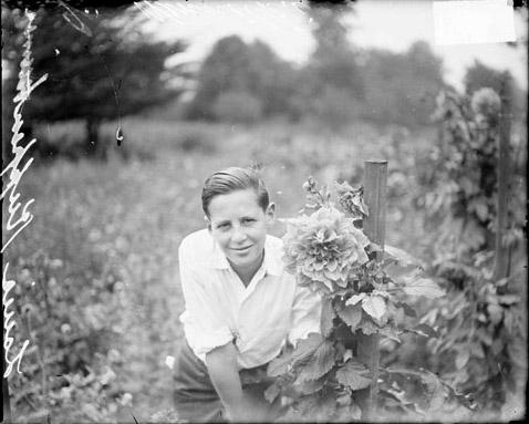 ECC | [Louis Kupperheimer standing and leaning over next to a larg