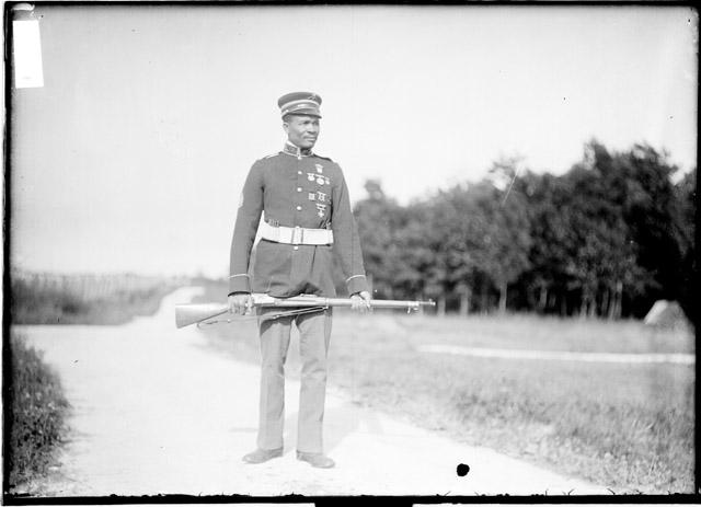 ECC | [African American sharpshooter standing with a rifle held le