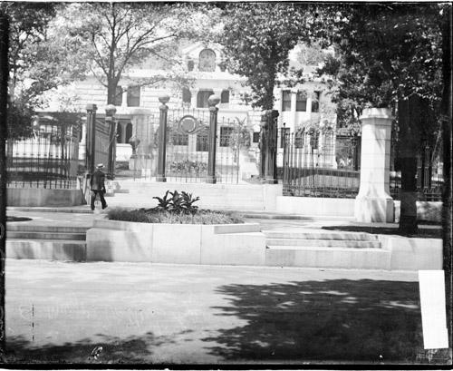 ECC | [James A. Patten's residence viewed beyond the gate, with a