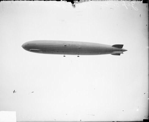 ECC | [Graf Zeppelin flying over Chicago, airplane visible flying