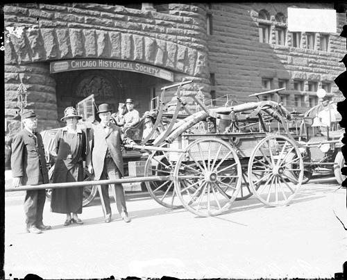 ECC | [Fireman and other people standing with old-fashioned fire e