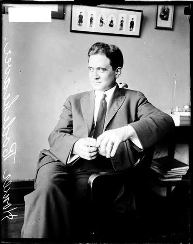 ECC | [Homer Rodeheaver sitting in a room, dark exposure]