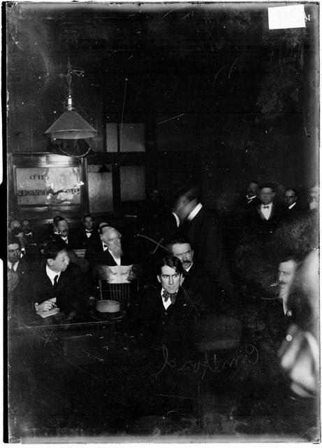 ECC | [Frank D. Comerford (center), sitting in a courtroom]