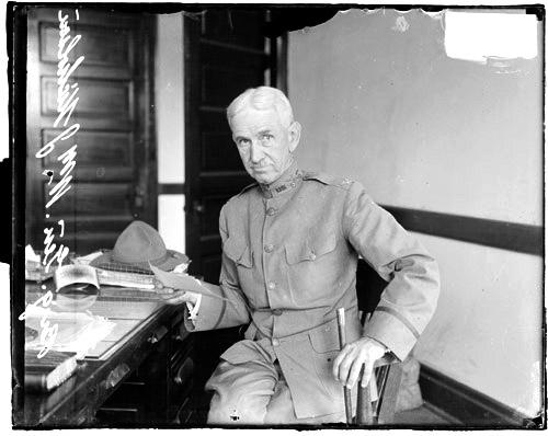 ECC | [U.S. Army Colonel William J. Nicholson sitting at a desk in