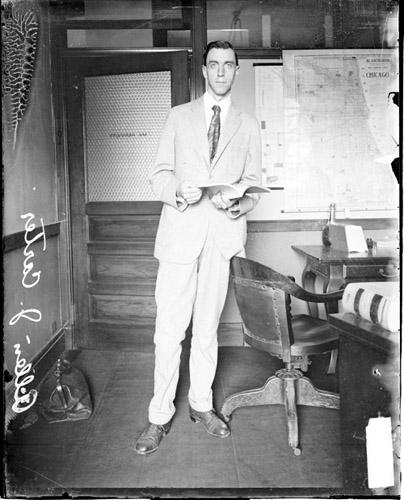 ECC | [Allen J. Carter, lawyer, standing in office, holding book]