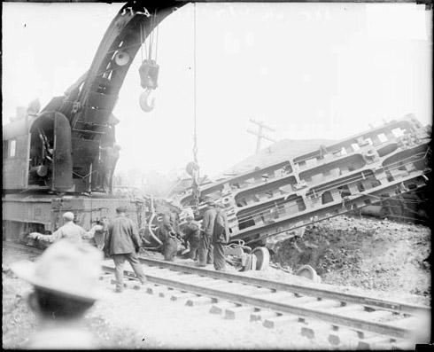 ECC | [Men standing in front of a wrecked train on a railroad trac