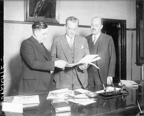 ECC | [Walter Strong looking at papers in his hands with Christian