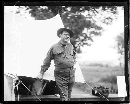 ECC | [Lt. Col. T. E. Brown standing outside a tent]