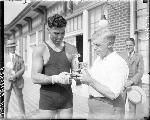 ECC | [Pugilist, Jack Dempsey, and Leo Flynn looking at a golf tro