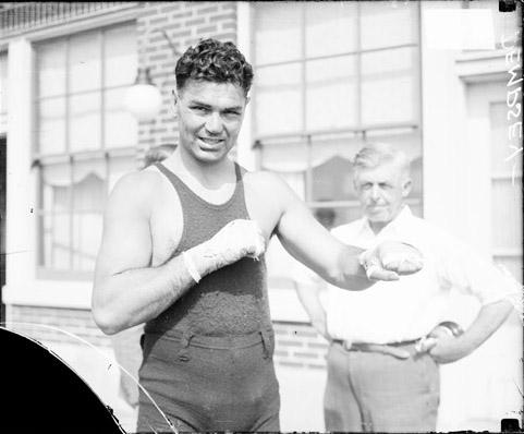 ECC | [Pugilist, Jack Dempsey clenching his hands into fists and h