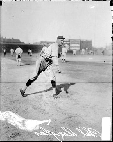ECC | [Baseball player, Phil Douglas throwing ball on field with p