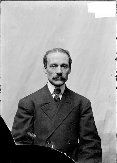 ECC | [Chess player, J. W. Taylor, sitting in front of a plain bac