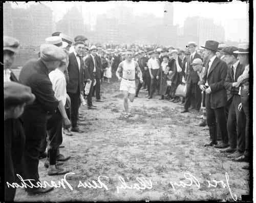 ECC | [I. A. C. athlete J. W. Ray running on a sandy surface durin